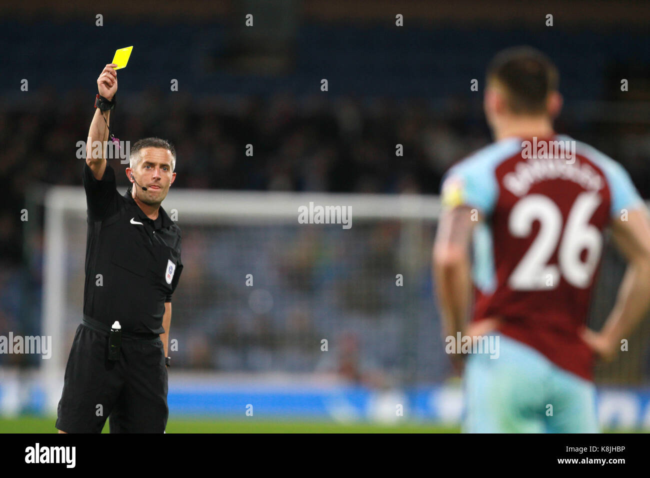 Referee Darren Bond shows Burnley's Phil Bardsley a yellow card during ...