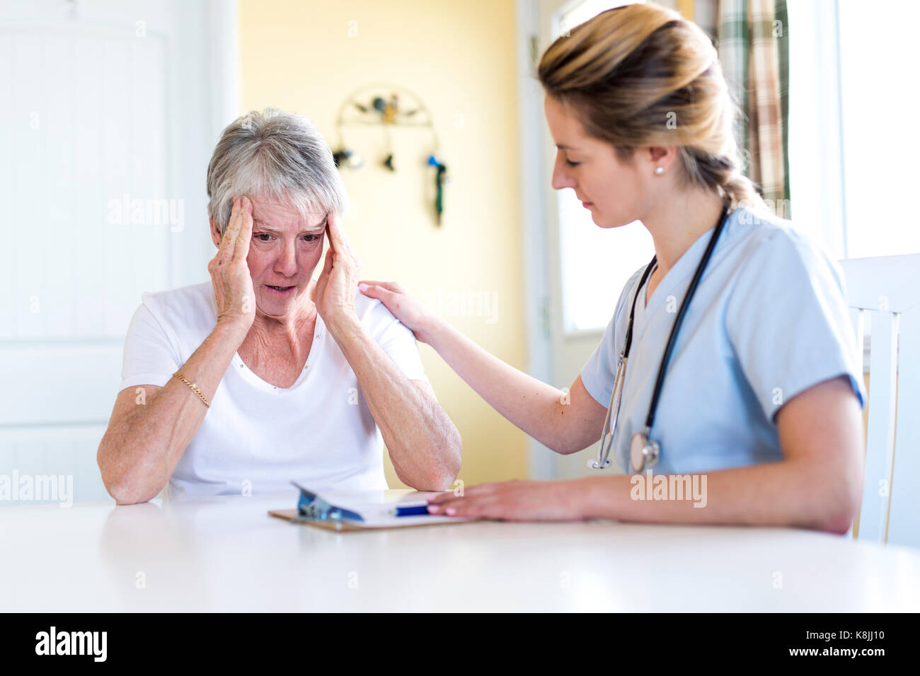 Senior woman with her caregiver at home Stock Photo - Alamy
