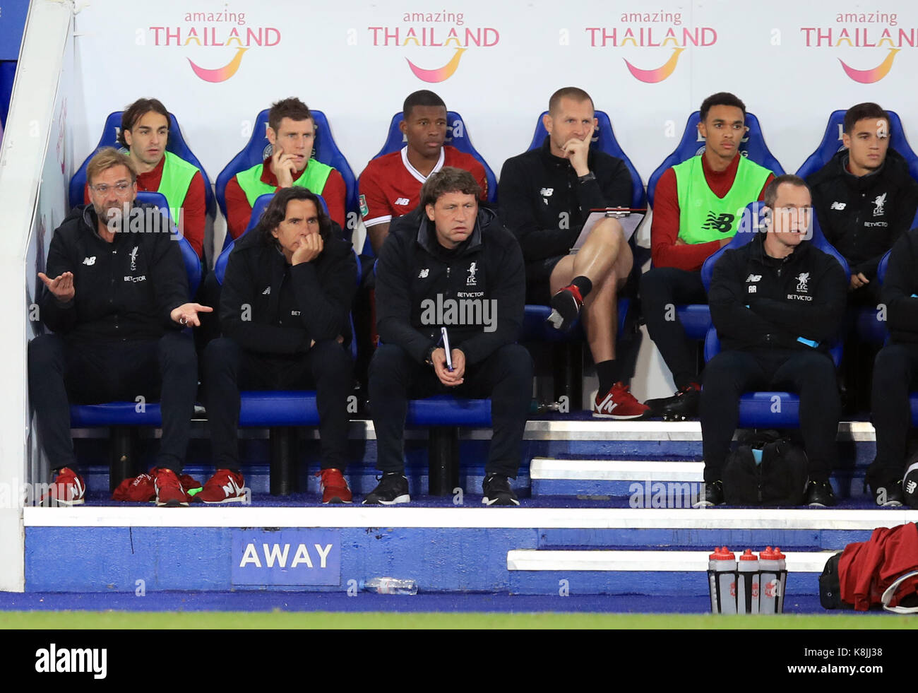 Liverpool manager Jurgen Klopp (left), players and staff sit dejected ...