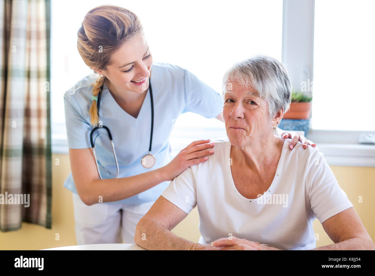 Senior woman with her caregiver at home Stock Photo - Alamy
