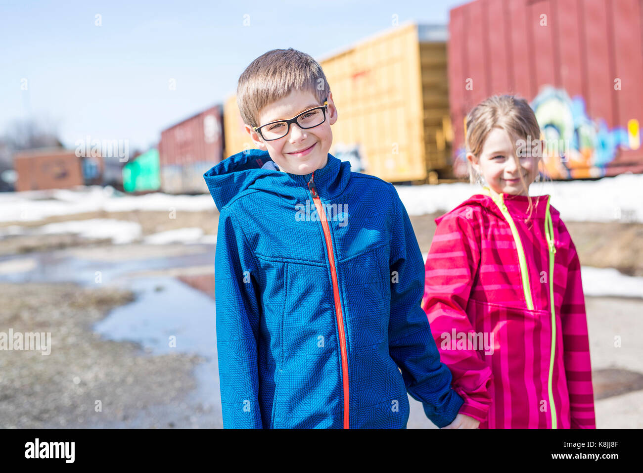 Brother and sister close to a train Stock Photo - Alamy