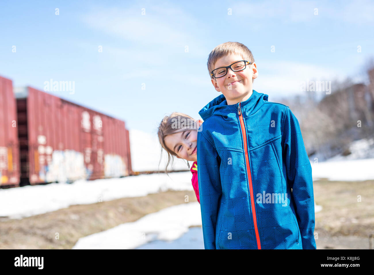 Brother and sister close to a train Stock Photo - Alamy