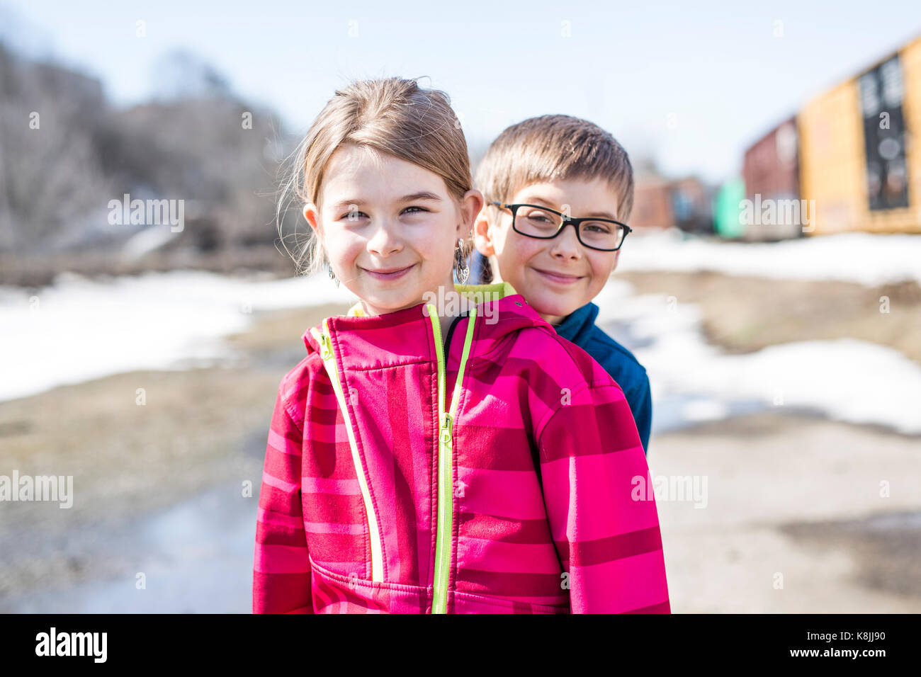 Brother and sister close to a train Stock Photo - Alamy