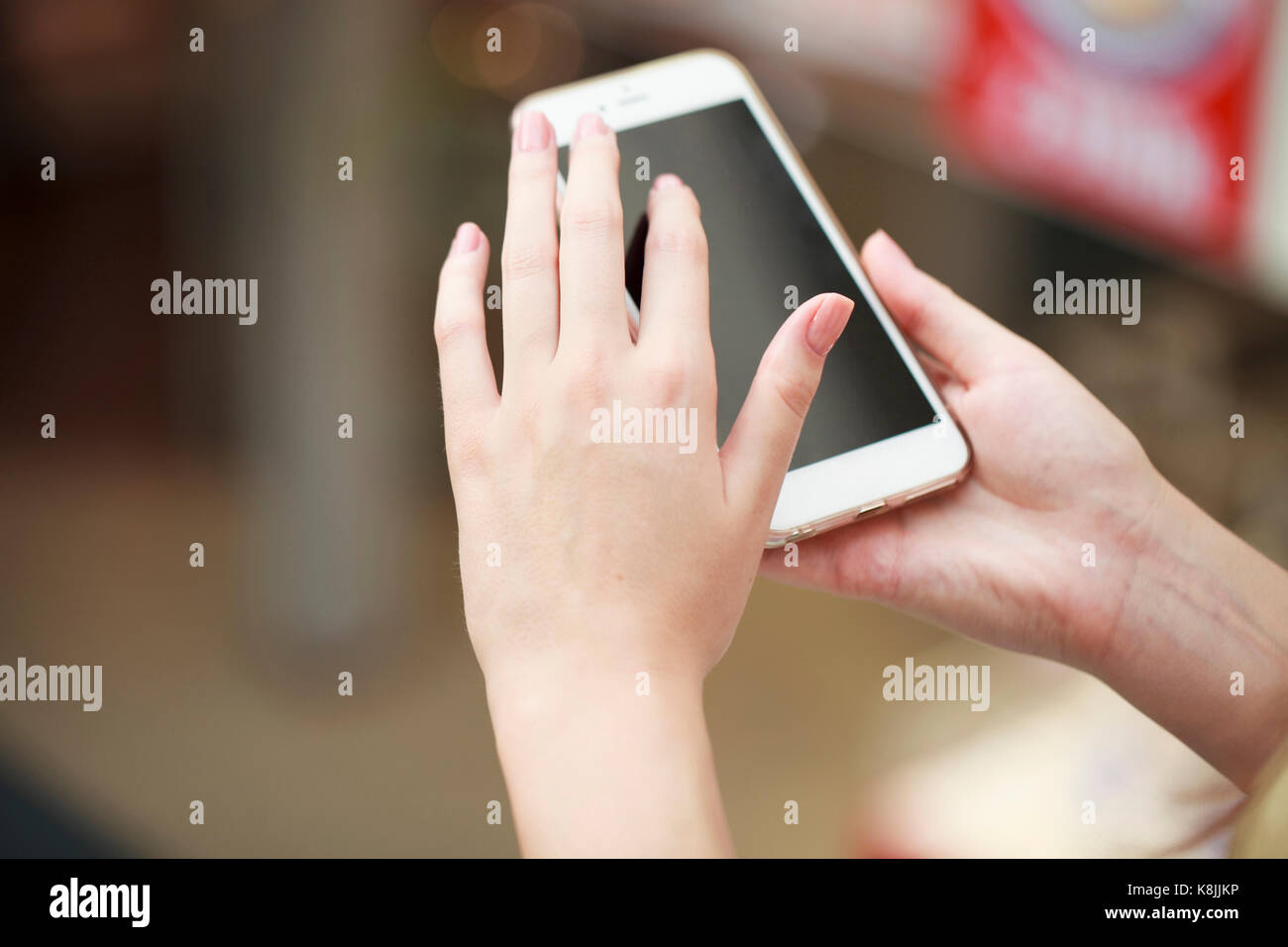 Beautiful female hands holding a mobile phone, indoor Stock Photo - Alamy