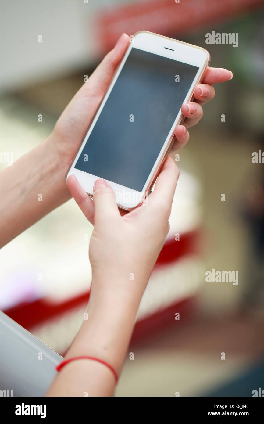 Beautiful female hands holding a mobile phone, indoor Stock Photo - Alamy