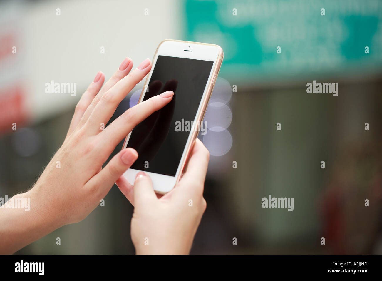 Beautiful female hands holding a mobile phone, indoor Stock Photo - Alamy