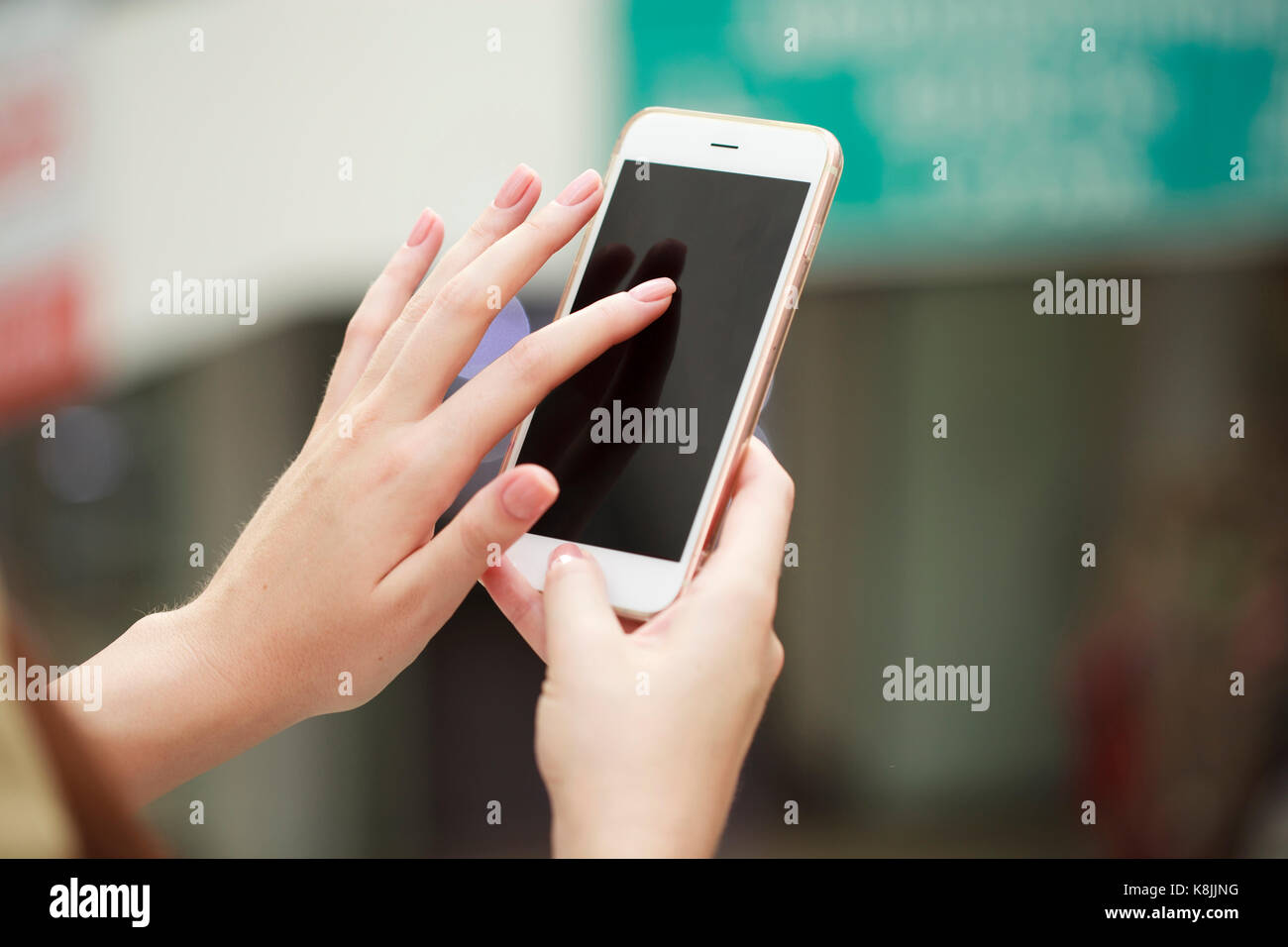 Beautiful female hands holding a mobile phone, indoor Stock Photo - Alamy