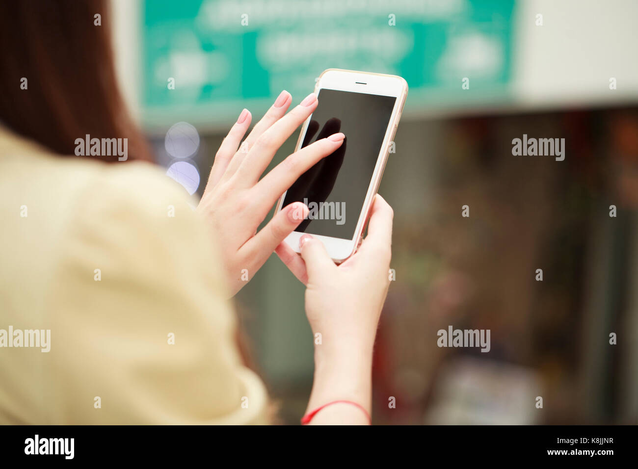 Beautiful female hands holding a mobile phone, indoor Stock Photo - Alamy