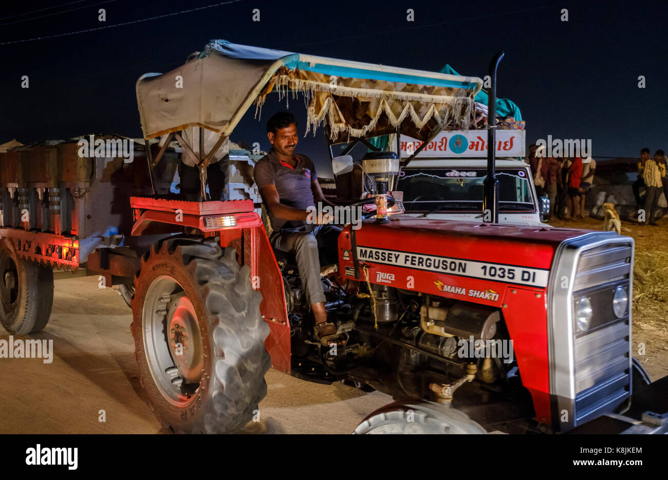 PUSHKAR, INDIA - CIRCA NOVEMBER 2016: Man driving a tractor at night ...