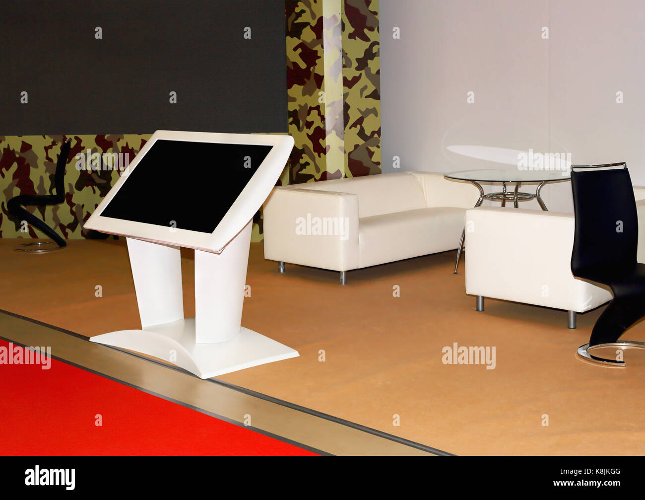 Detail of the interior in the exhibition hall with a desk, a couch and ...