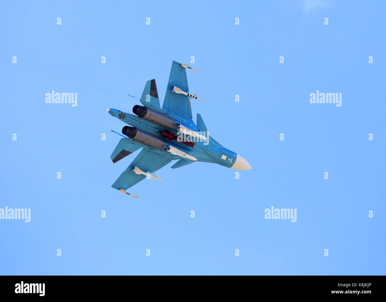 Russian fighter with rockets flying in a blue sky Stock Photo - Alamy