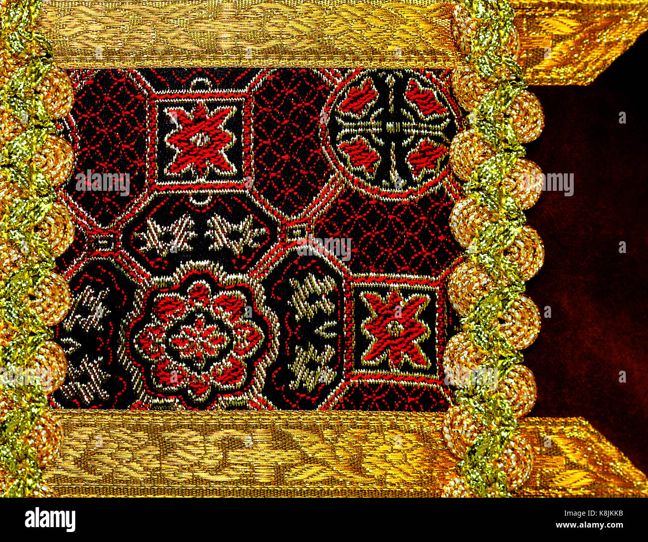 Colorful fabric with patterns of red and gold stitch Stock Photo - Alamy