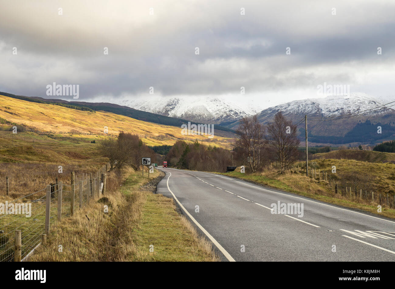 A82 road with speed camera sign with snow capped mountains in the ...