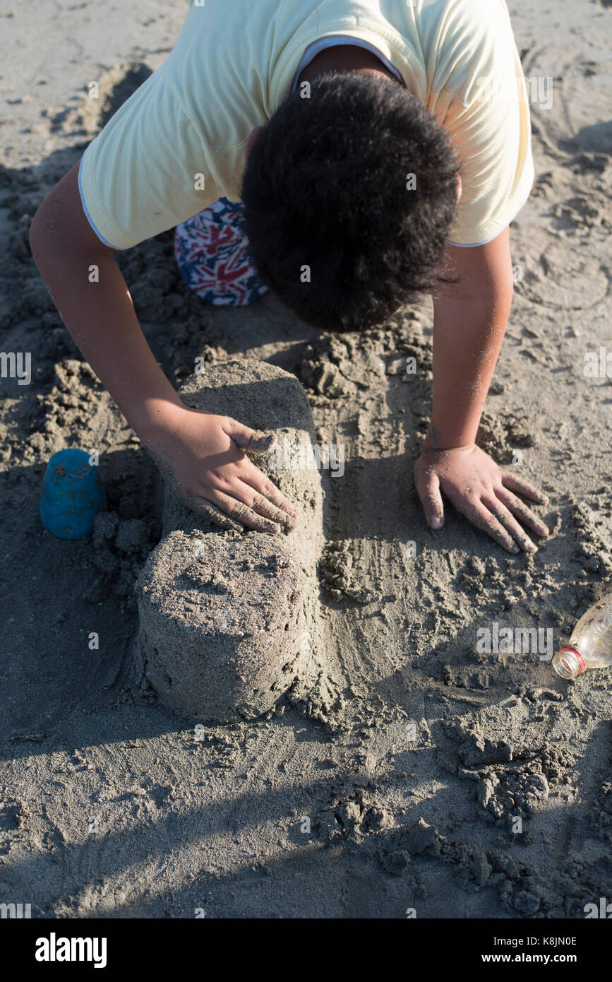 Child making a sand castle hi-res stock photography and images - Alamy