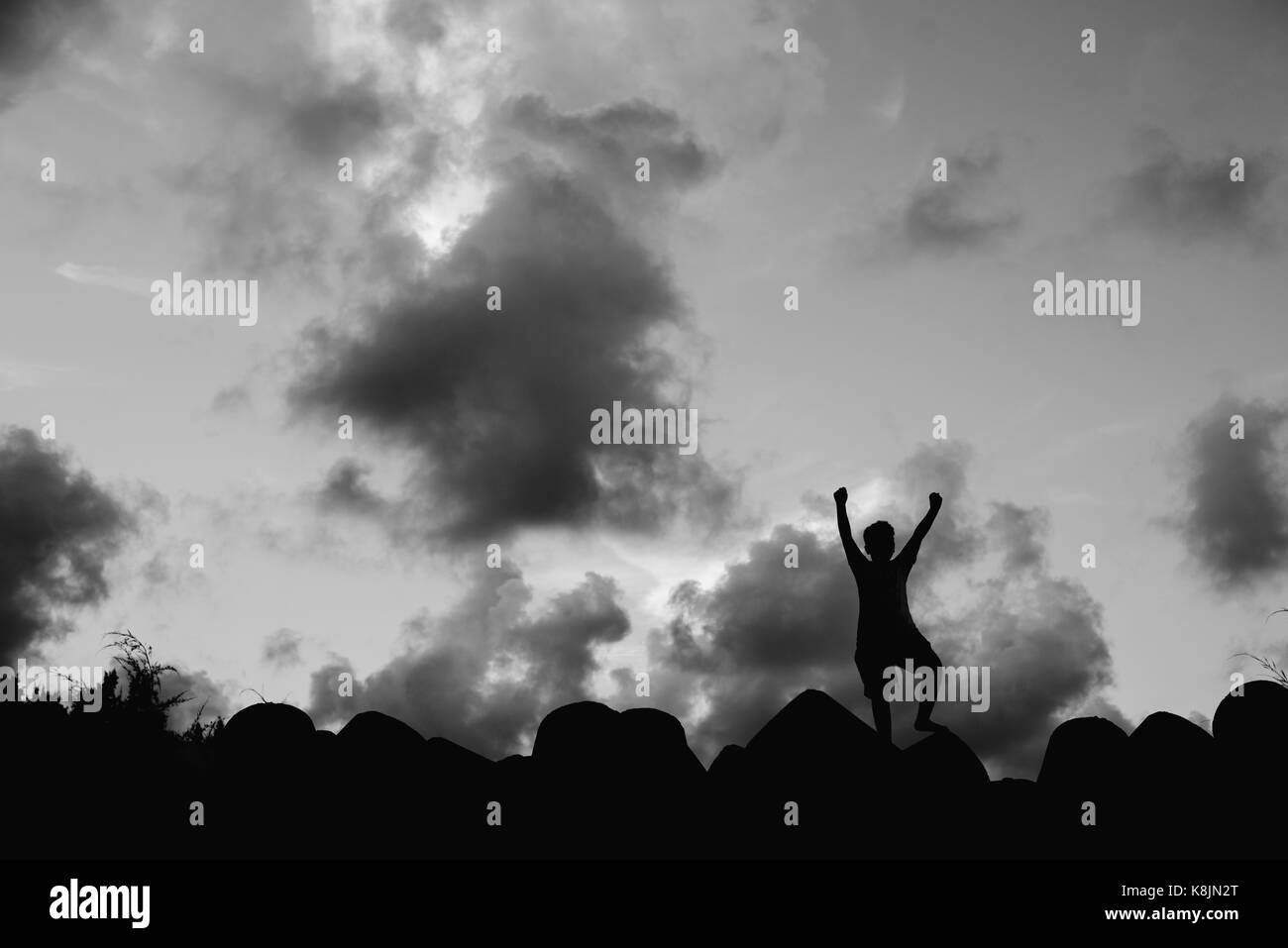 silhouette photo of a boy raised his hand.symbol of freedom and success ...