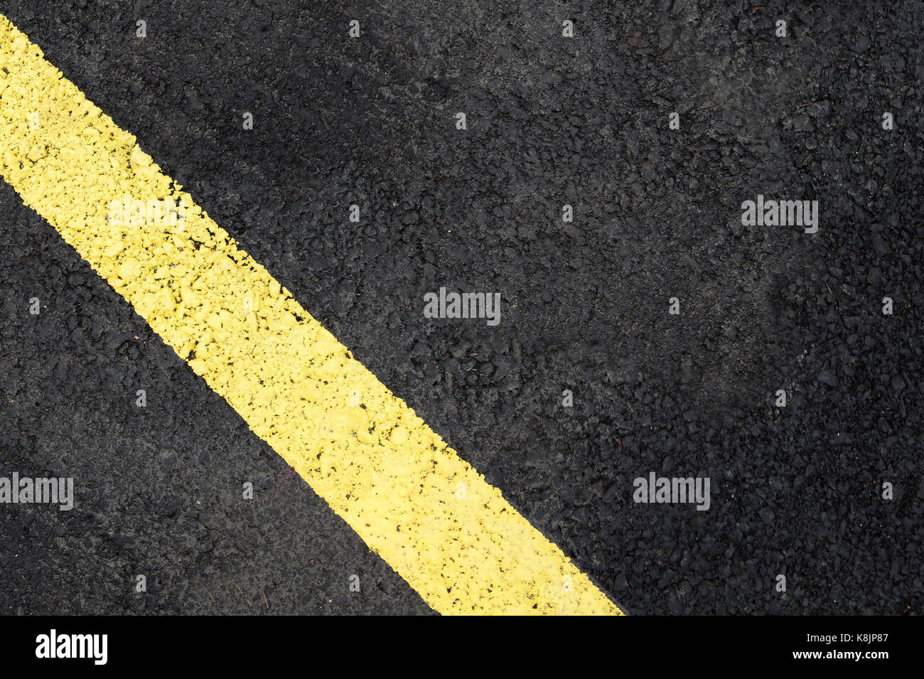 grungy, dirty view of asphalt with distinct yellow stripe Stock Photo ...