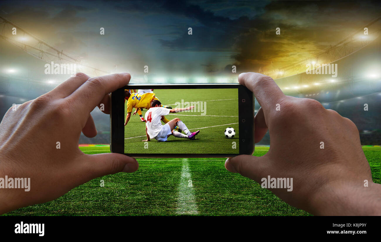 Football fan removes the football game on mobile phone Stock Photo - Alamy