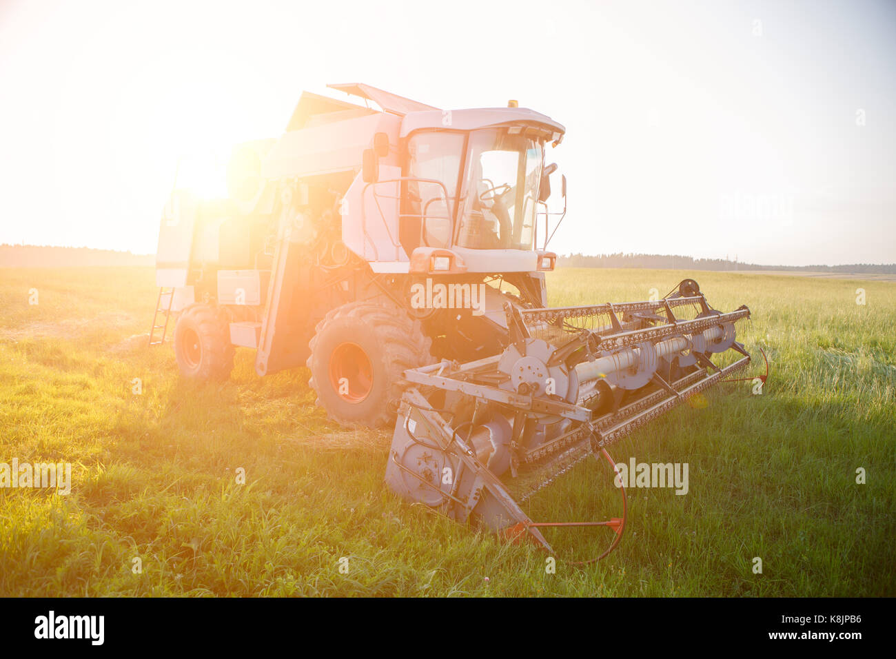 Picture of combine at work in field Stock Photo - Alamy