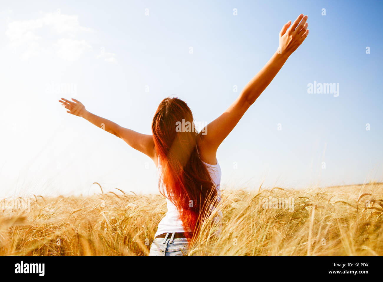 Photo from back of woman with arms raised Stock Photo - Alamy