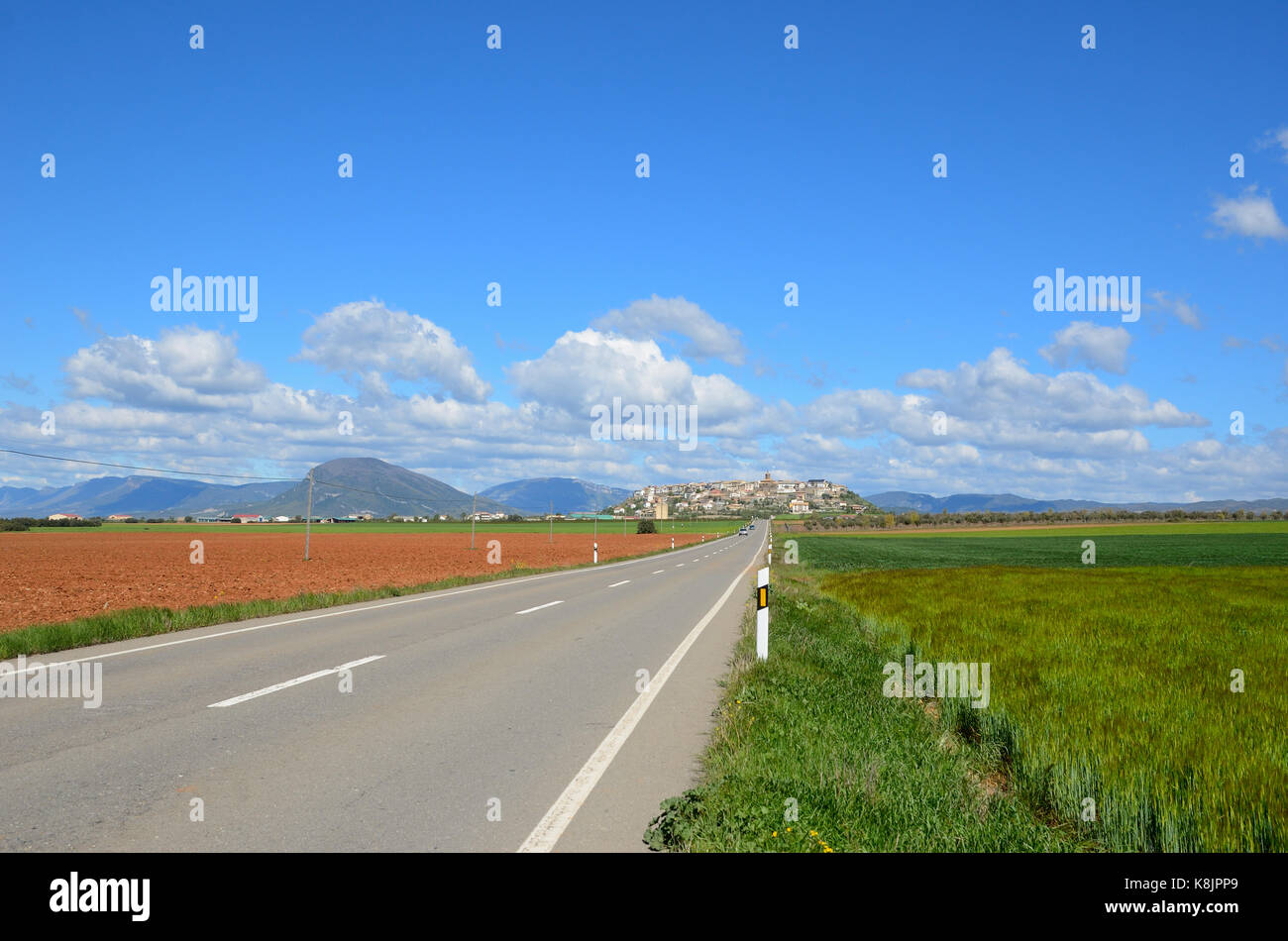 The road leads to the Spanish town Berdun on the hill surrounded with ...