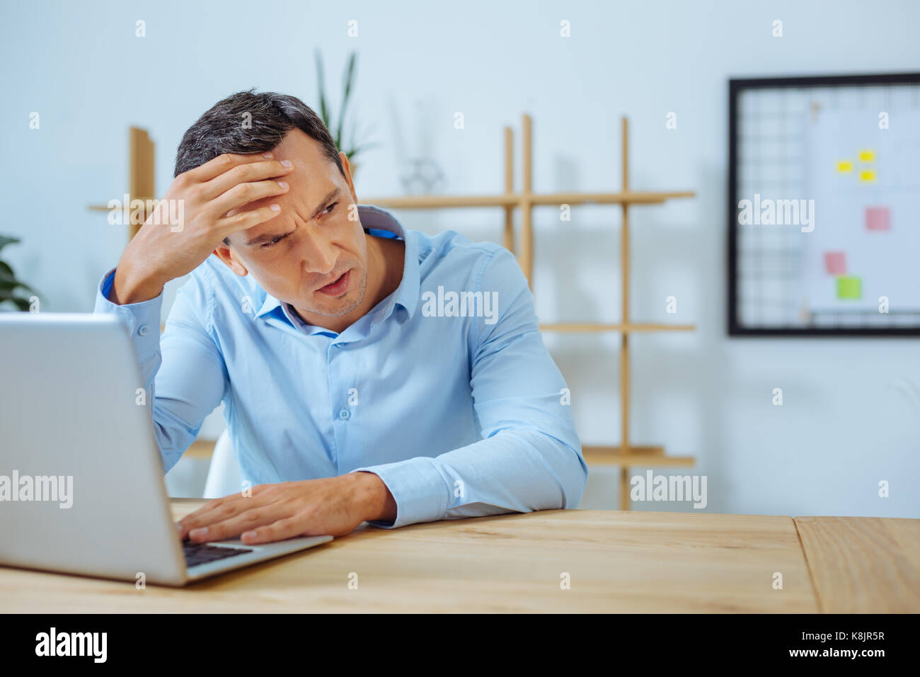 Confident male working with computer Stock Photo - Alamy