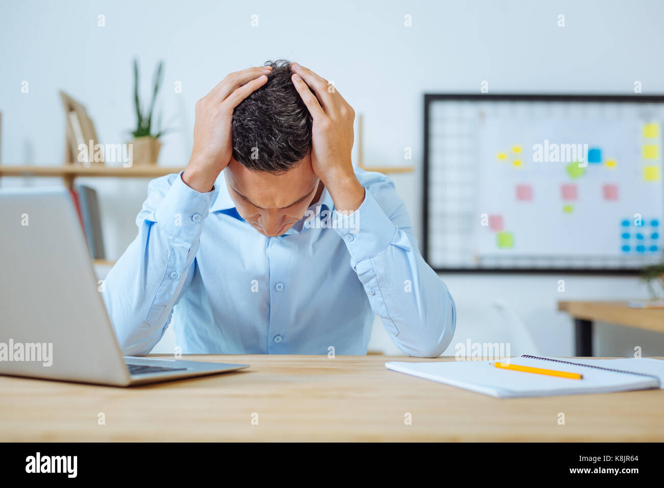 Worried male person touching his head Stock Photo - Alamy