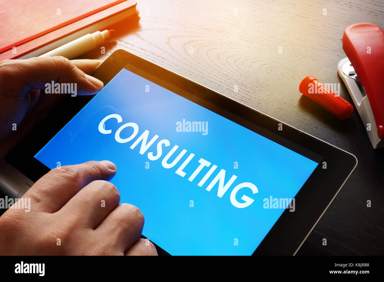 Online Consulting concept. Advisor is holding tablet Stock Photo - Alamy