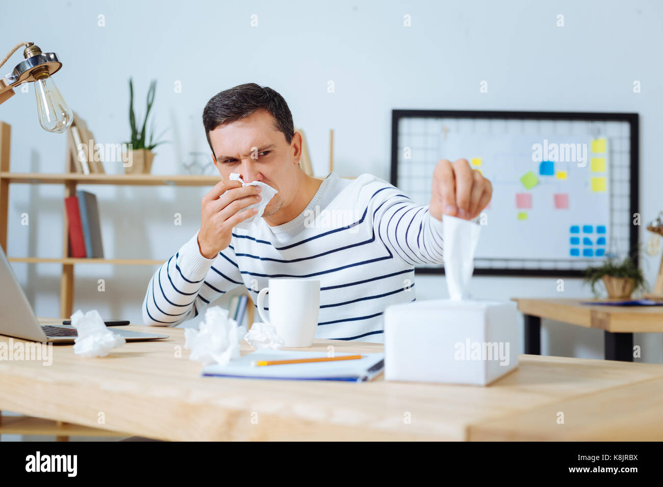 Serious man feeling bad while working Stock Photo - Alamy