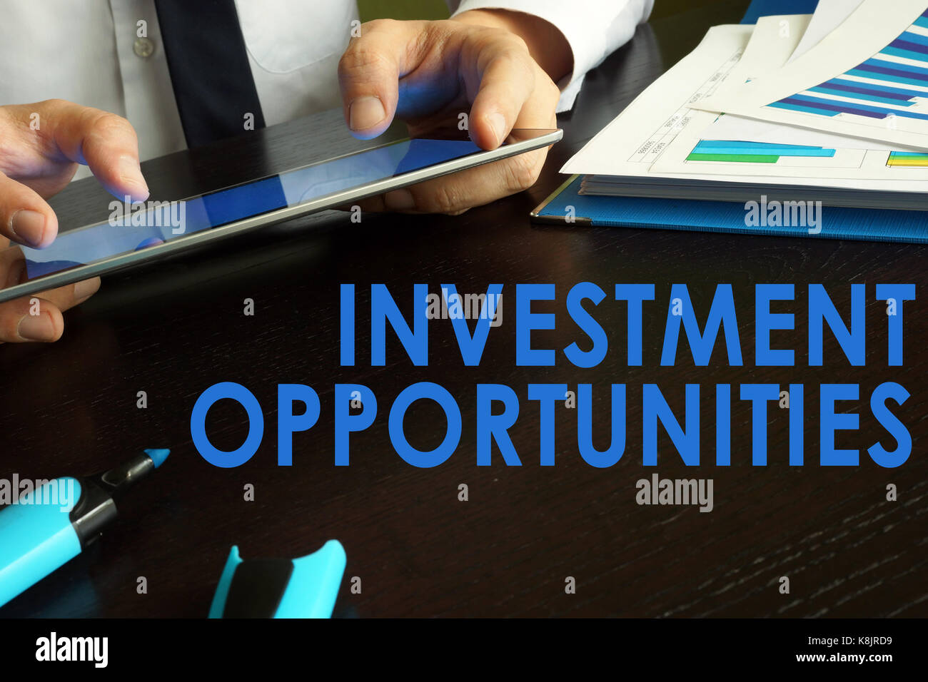 Investment opportunities concept. Businessman is using tablet Stock ...