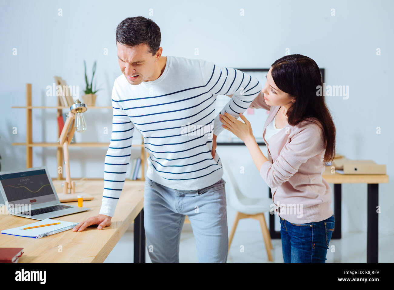 Kind woman helping her colleague Stock Photo - Alamy
