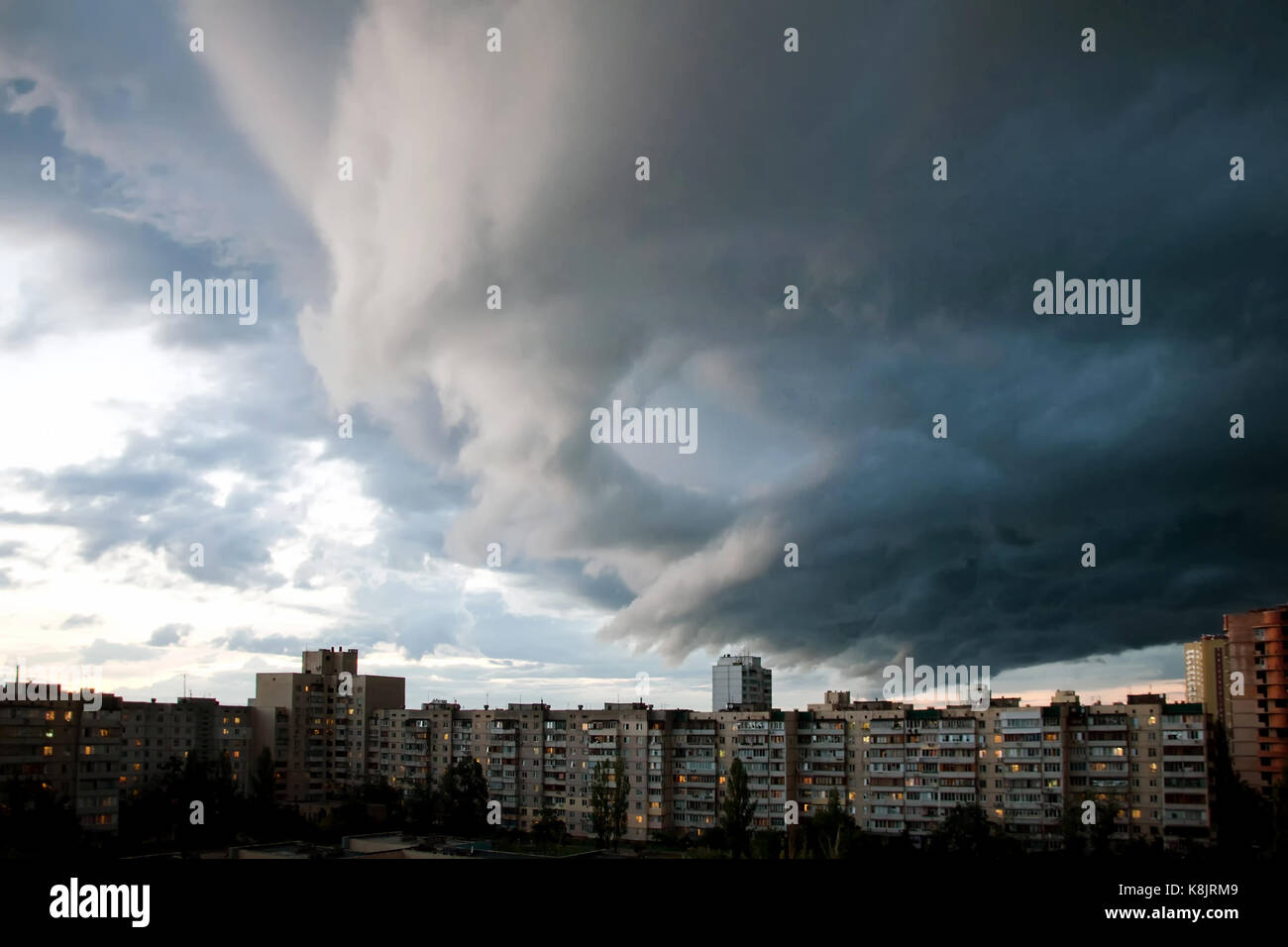 Heavy rain clouds over the city. Stormy sky over the buildings. Typical ...