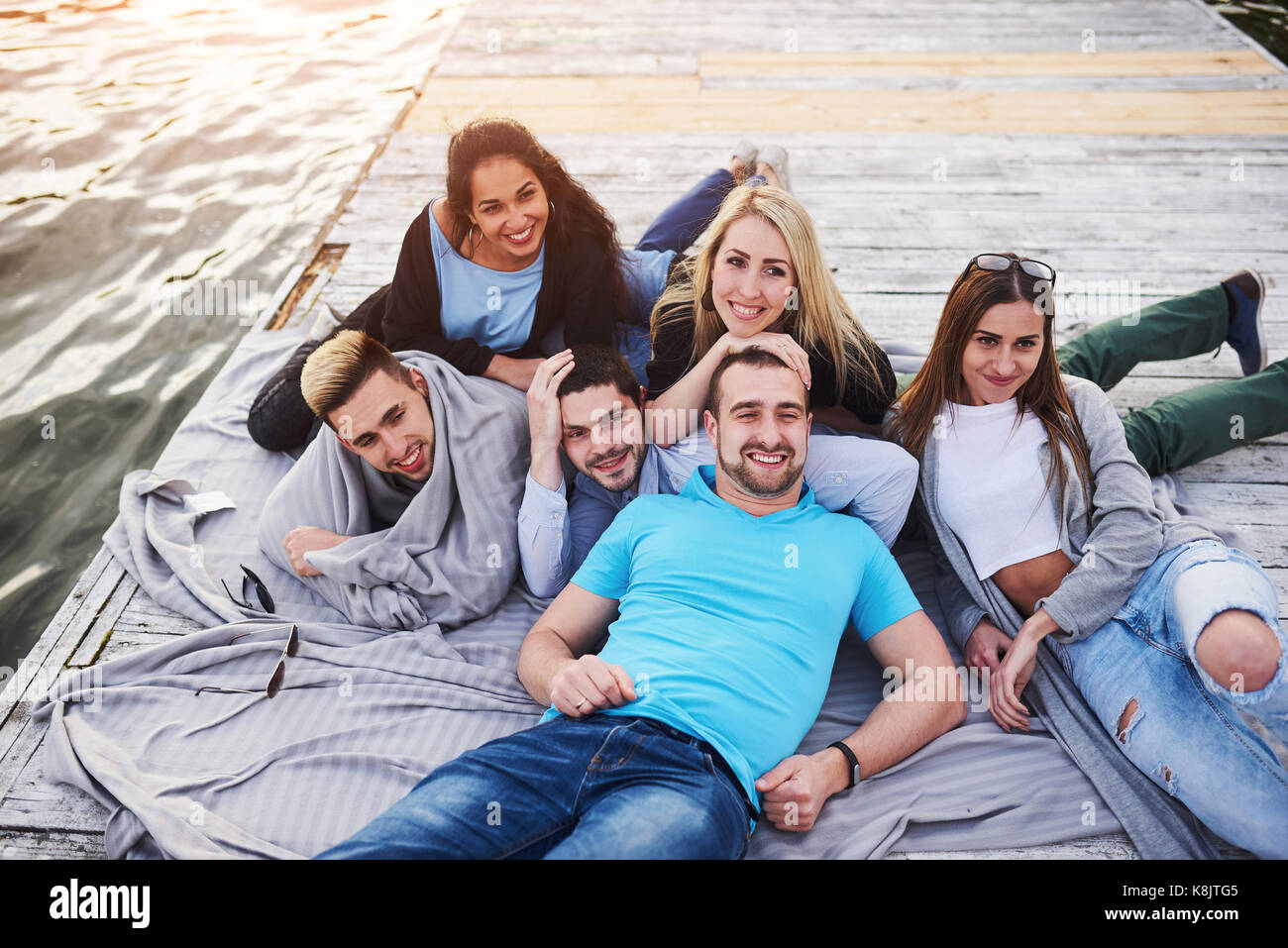 Group of happy beautiful young people who are doing Village on the pier ...
