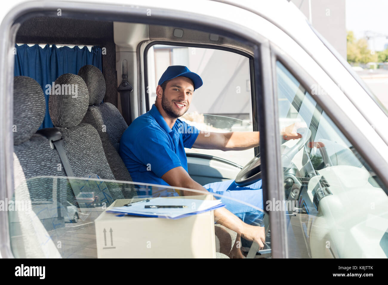 delivery man sitting in car Stock Photo - Alamy