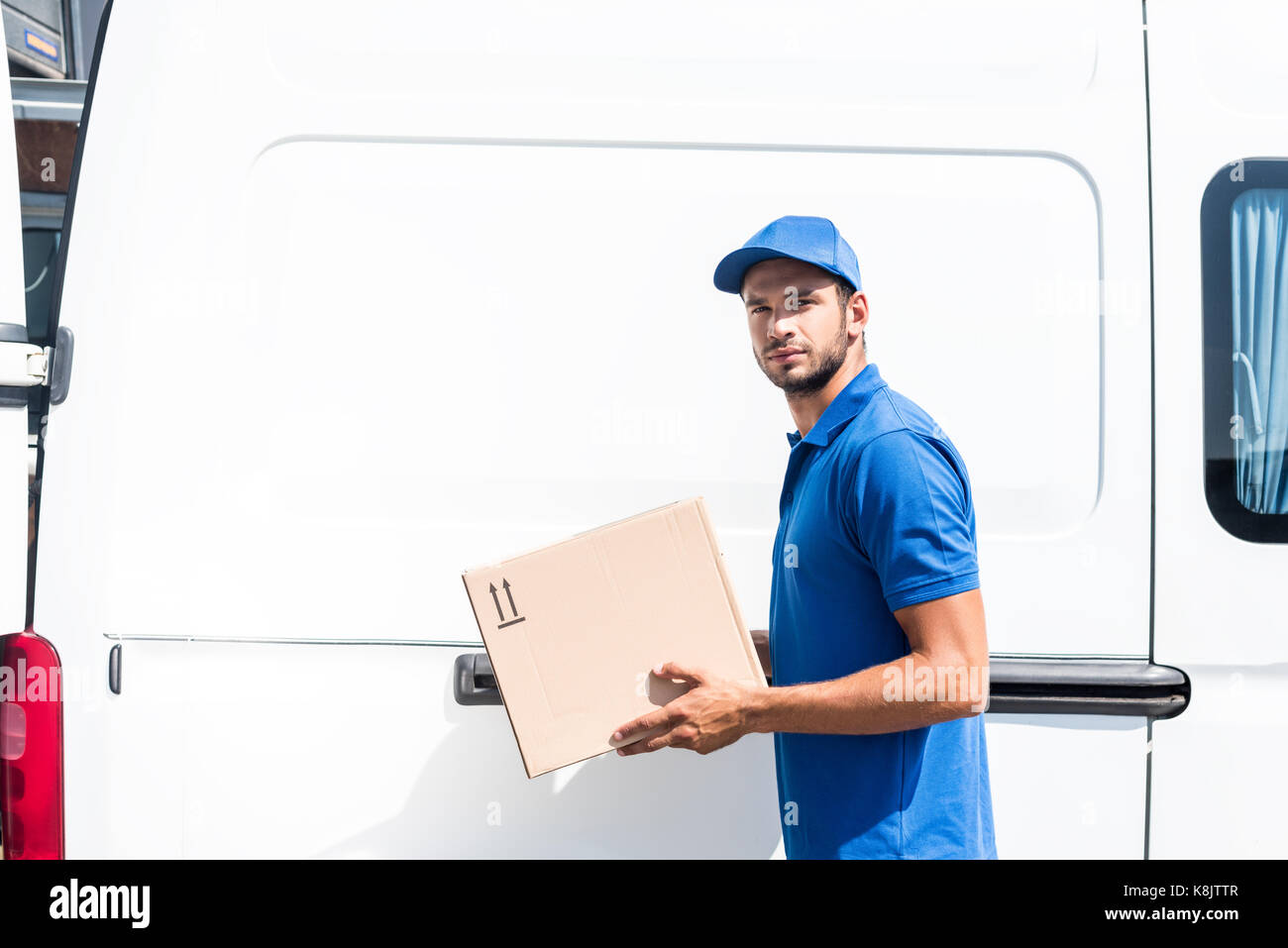delivery man with box Stock Photo - Alamy