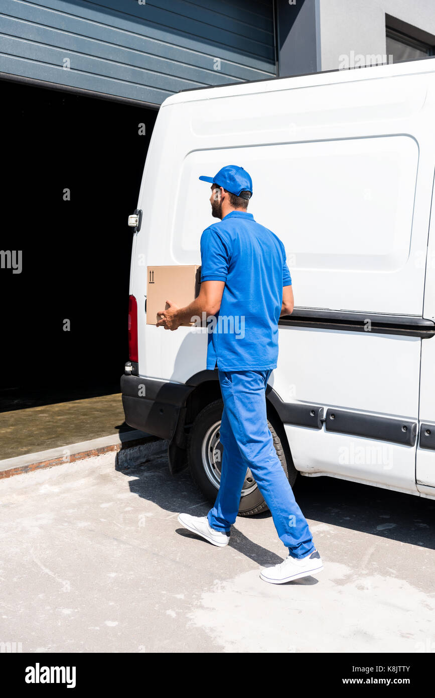 delivery man with box Stock Photo - Alamy