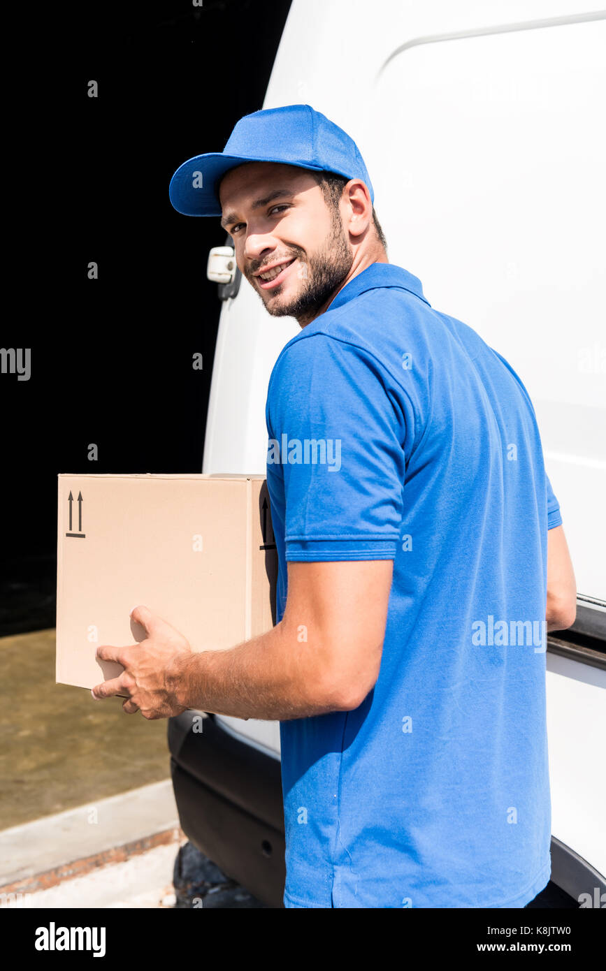 delivery man with box Stock Photo - Alamy