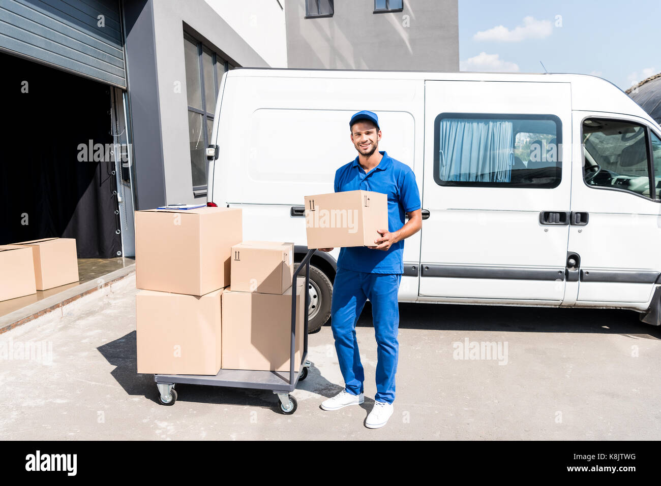 delivery man with box Stock Photo - Alamy