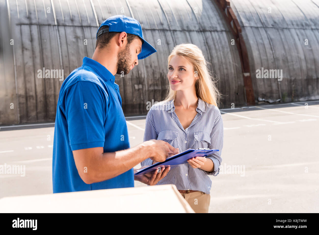 woman signing delivery document Stock Photo - Alamy