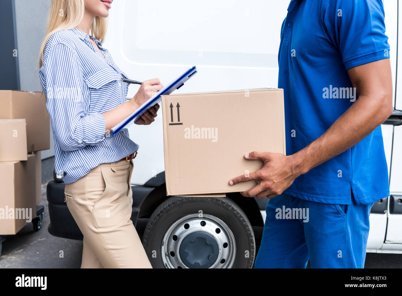 Female courier carrying box hi-res stock photography and images - Alamy