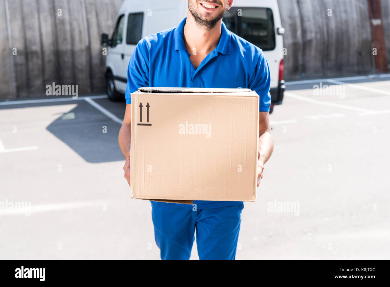 delivery man with cardboard box Stock Photo - Alamy