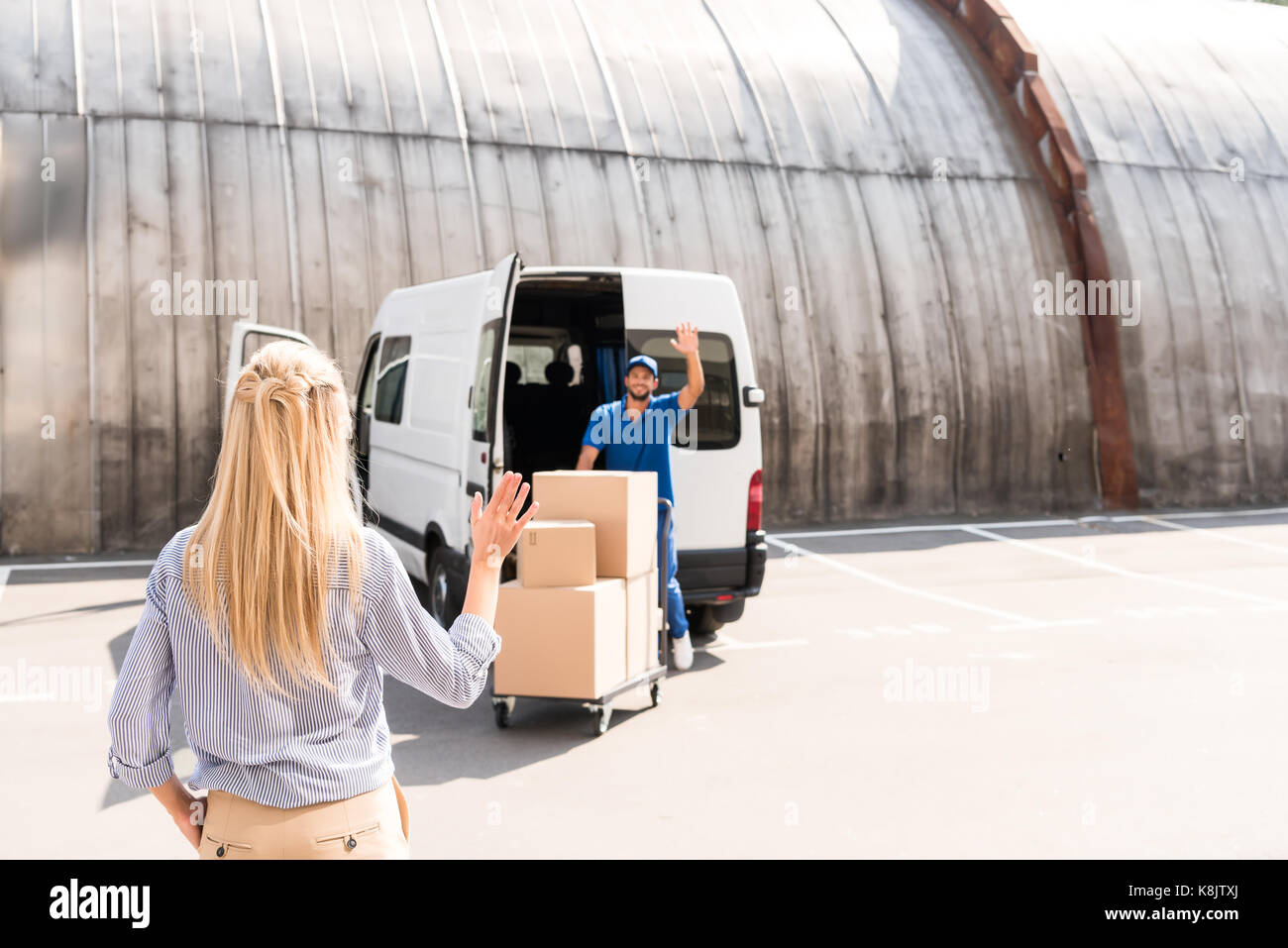 courier delivering packages for woman Stock Photo - Alamy