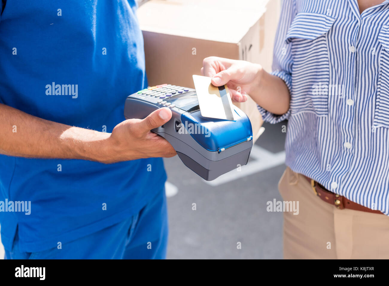 woman paying for delivery with card Stock Photo - Alamy