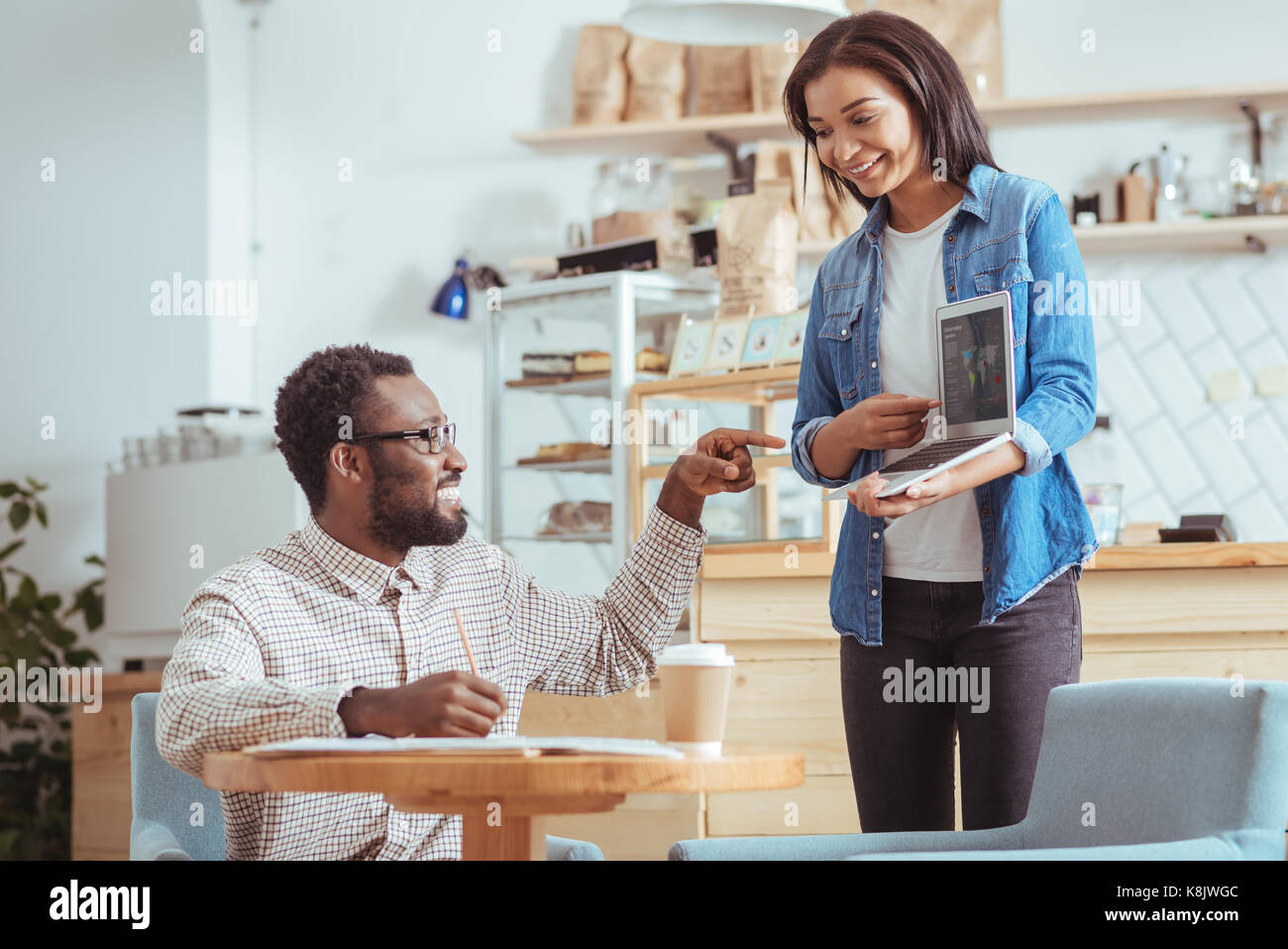 Pleasant man asking questions during colleagues presentation Stock ...