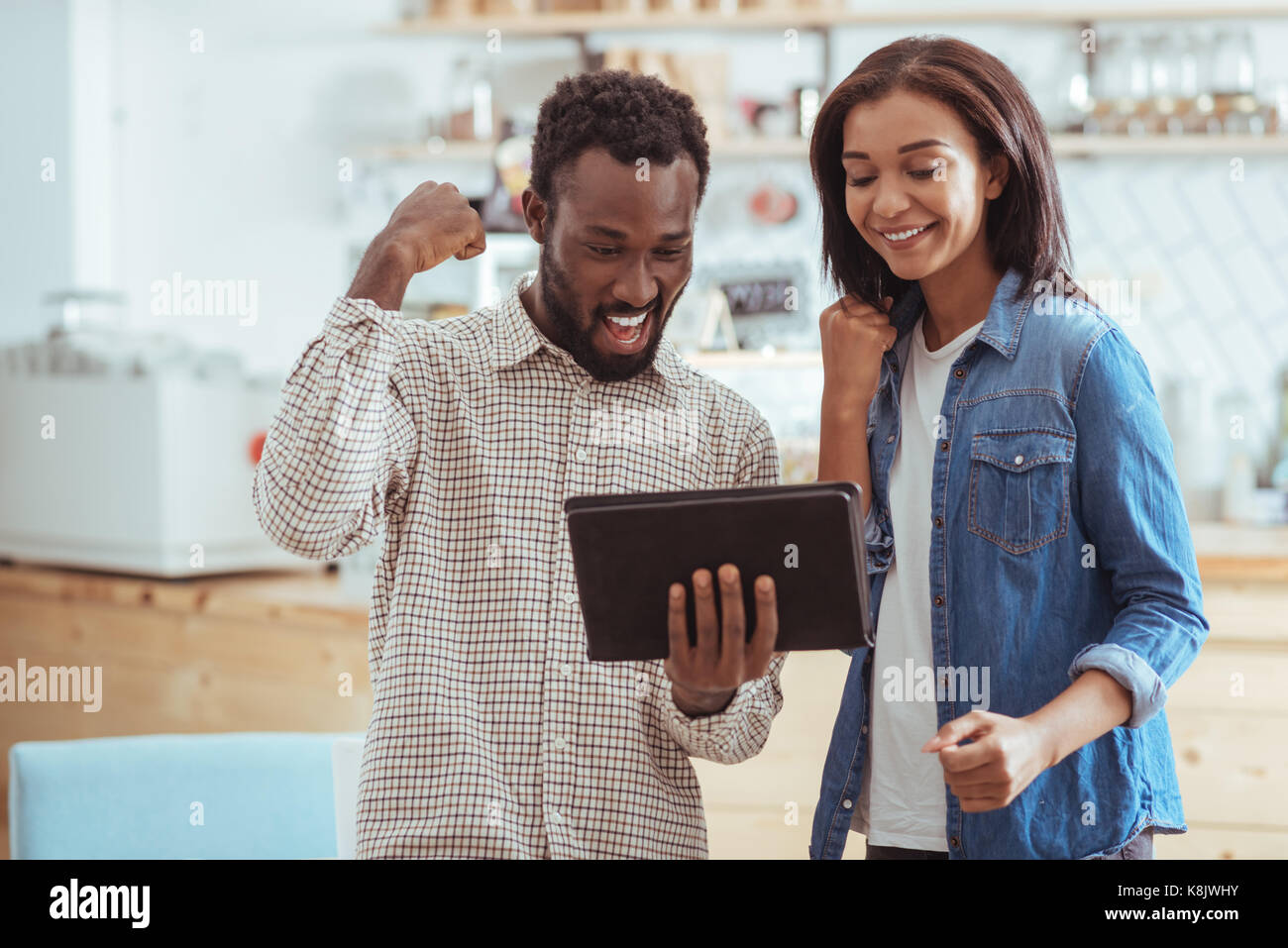 Upbeat friends celebrating award of grant for startup Stock Photo - Alamy