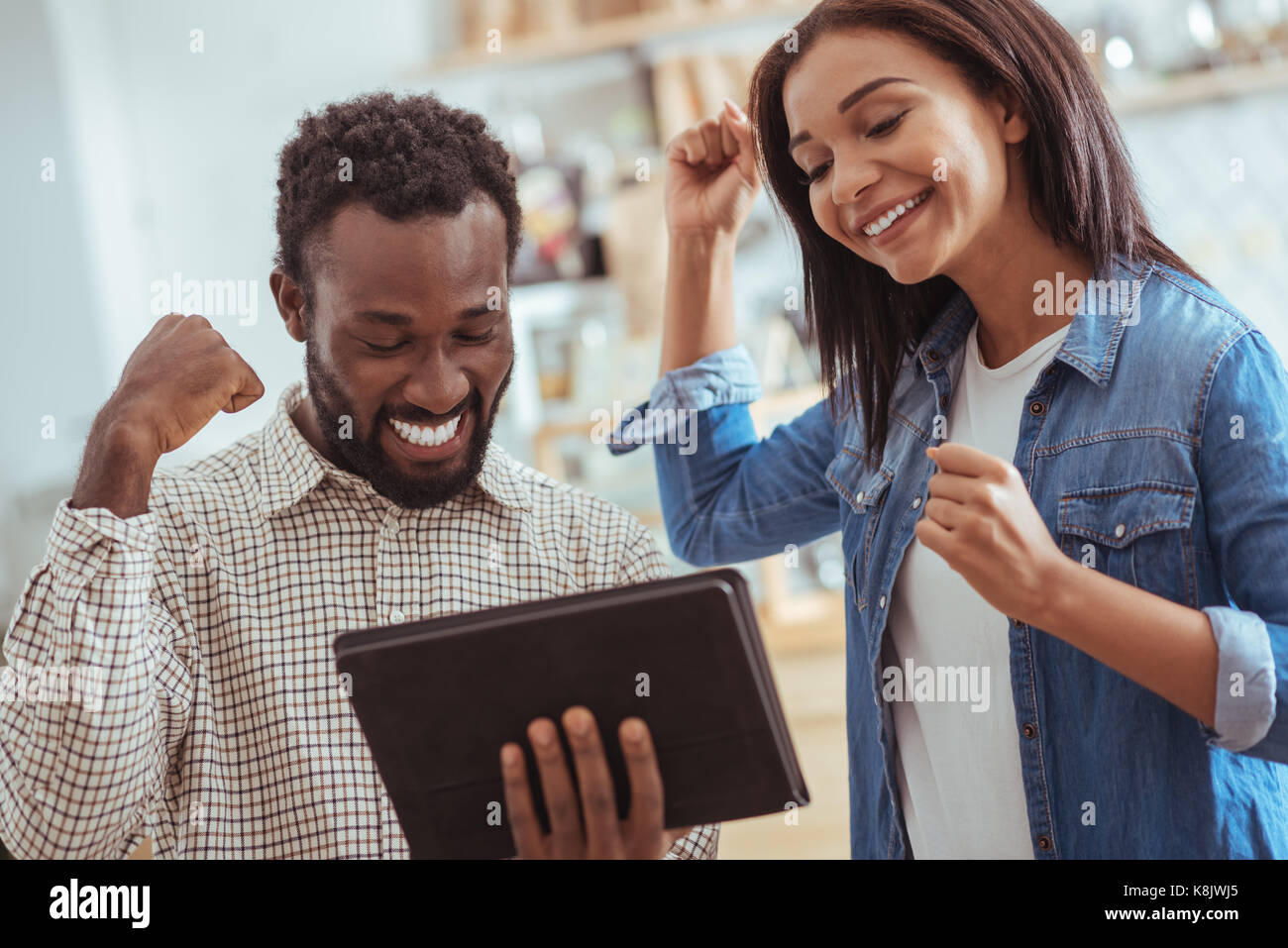 Cheerful friends celebrating good news having read email Stock Photo ...