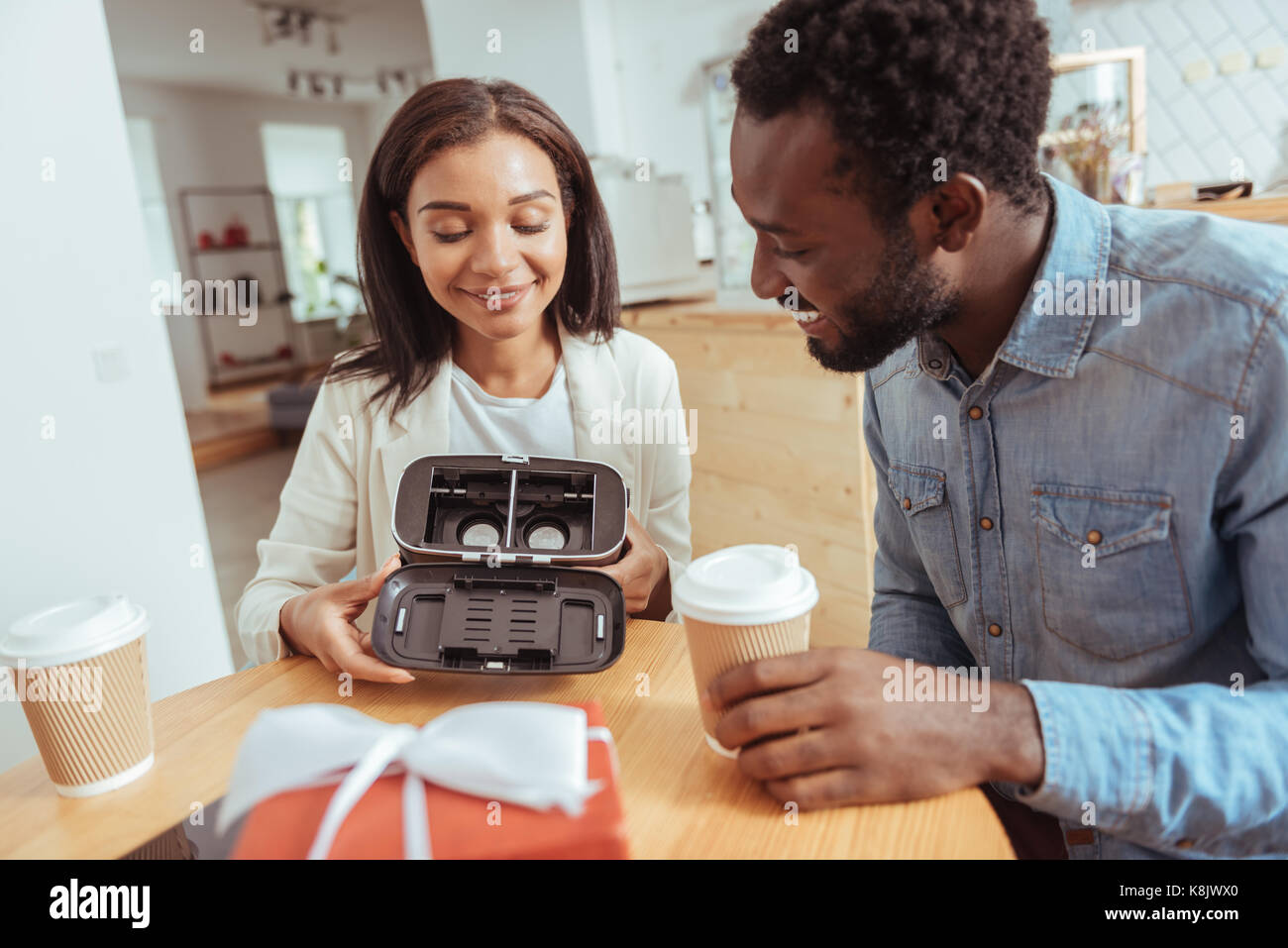 Beautiful woman showing interior part of VR headset Stock Photo - Alamy