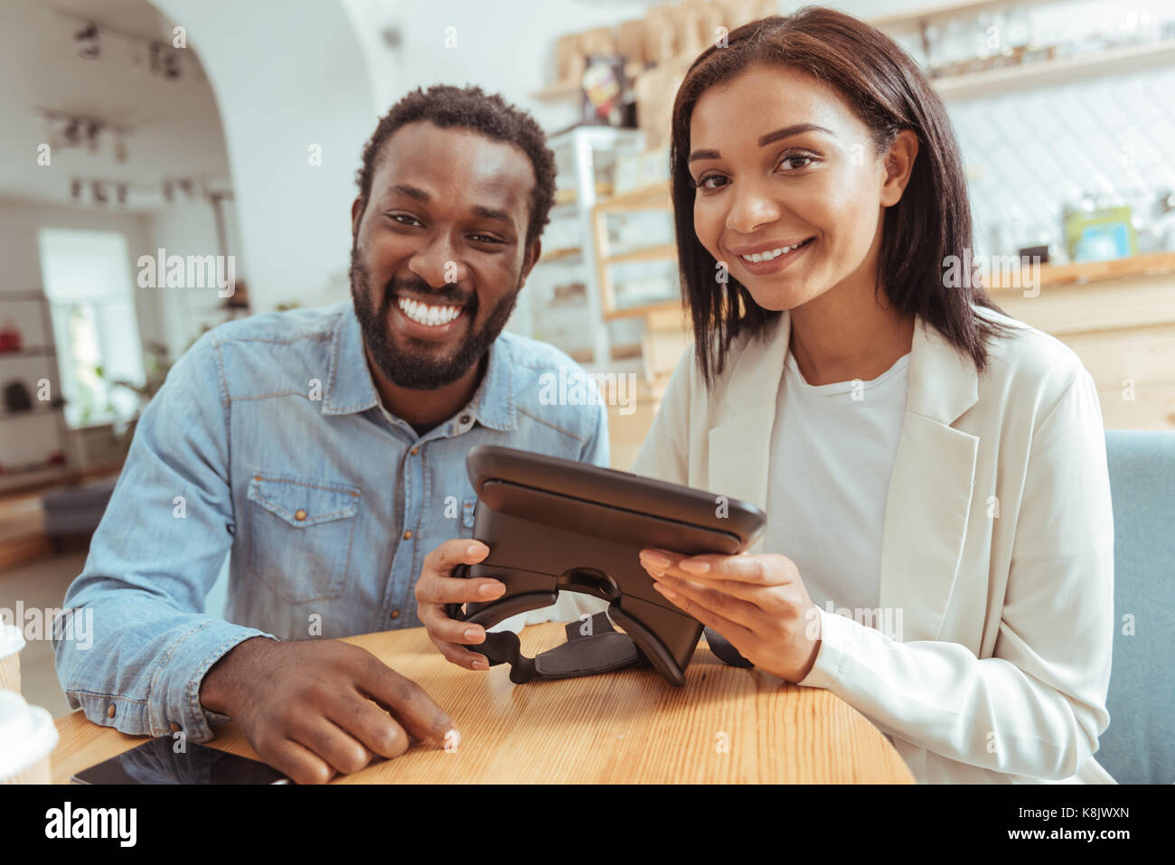 Cheerful best friends posing with VR headset in coffeehouse Stock Photo ...