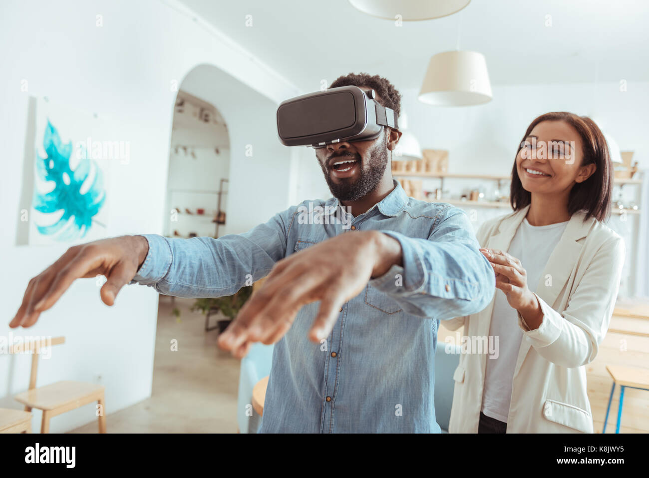 Excited man playing with VR headset in coffeehouse Stock Photo - Alamy