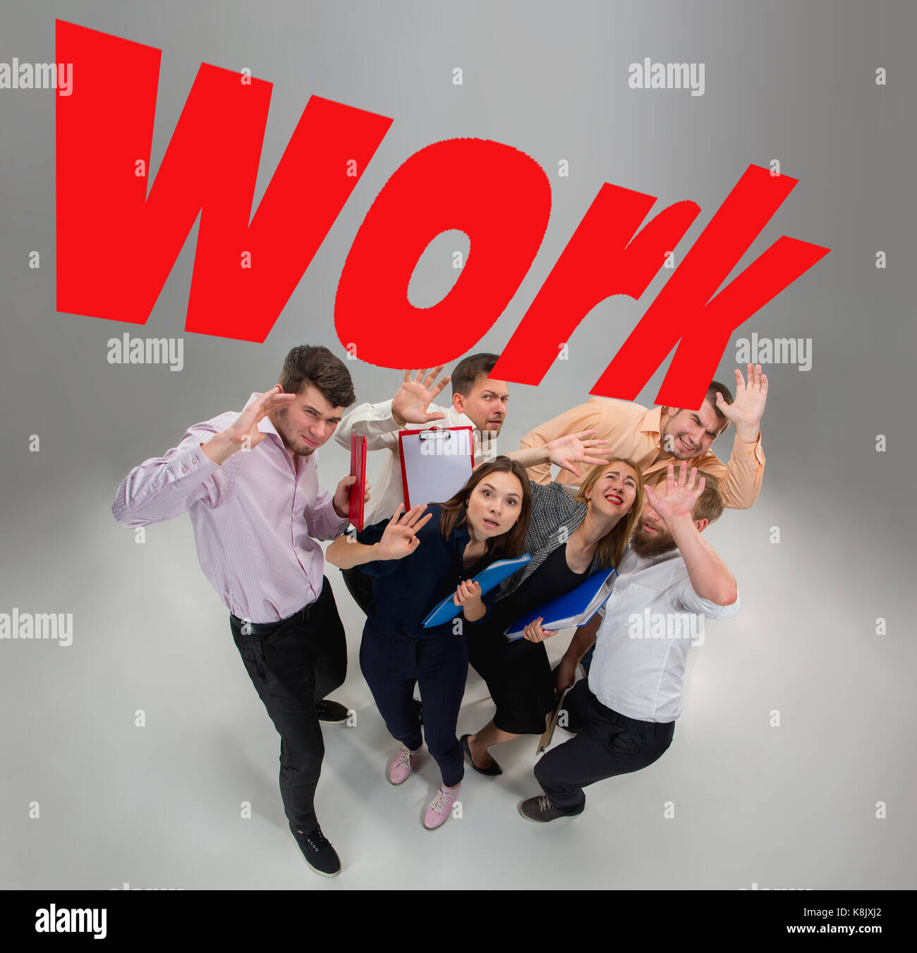 Scared and shocked team of young business men and women under world ...