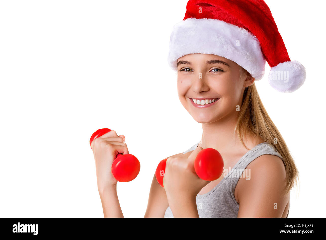 Fitness christmas young girl training lifting hand weight wearing santa ...